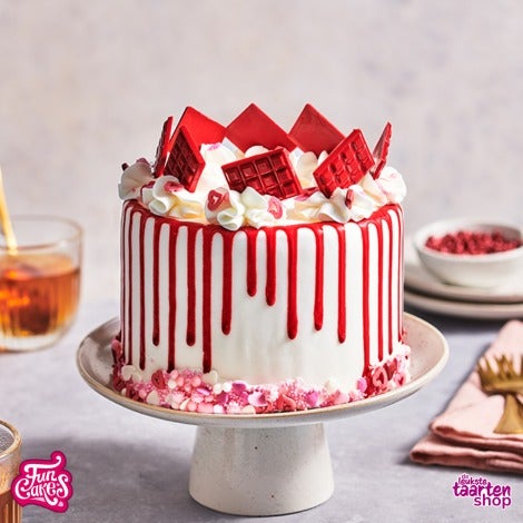 Red drip cake with sprinkles and choco bars